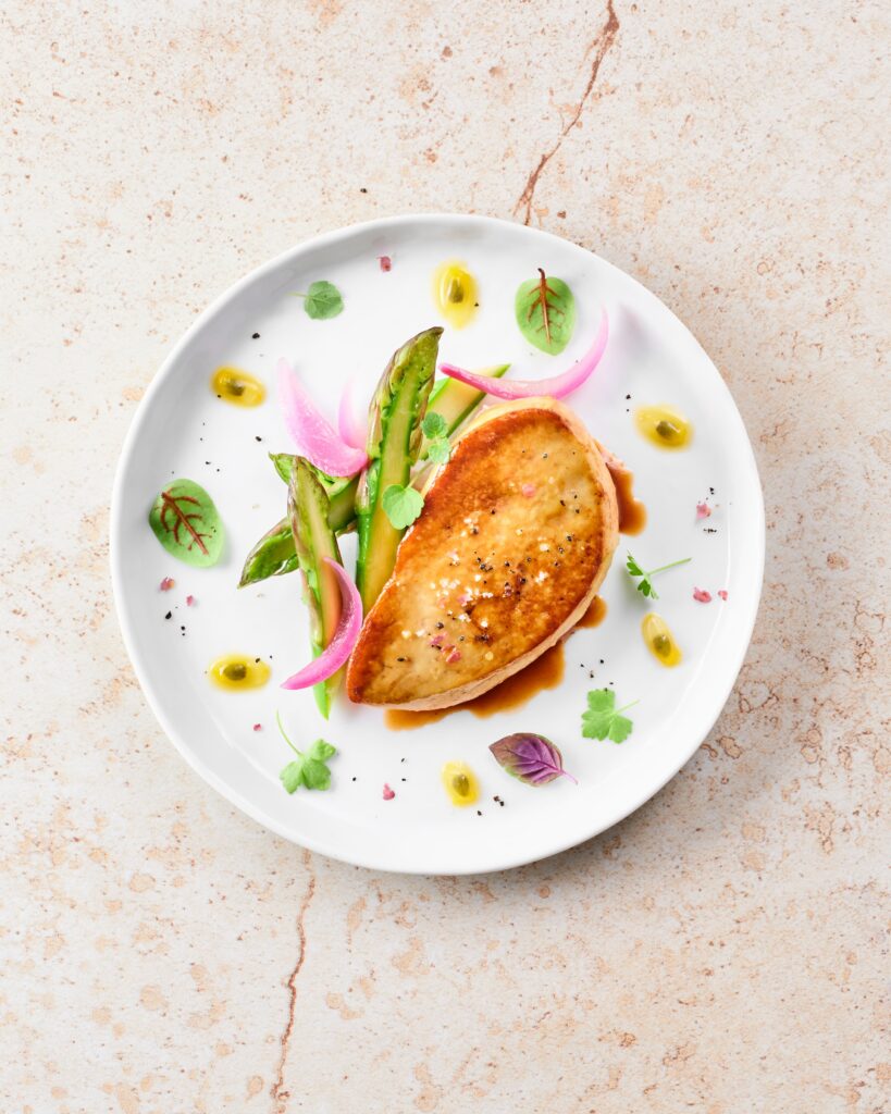 Pan-seared foie gras escalope, reduced duck jus, and spring vegetables ...